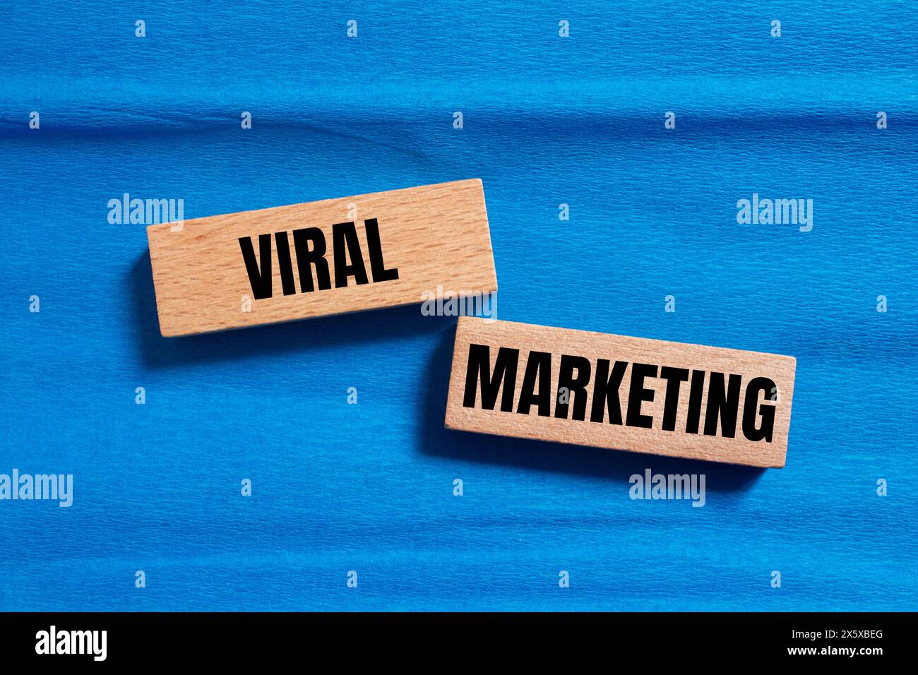 Viral marketing words written on wooden blocks with blue background ...