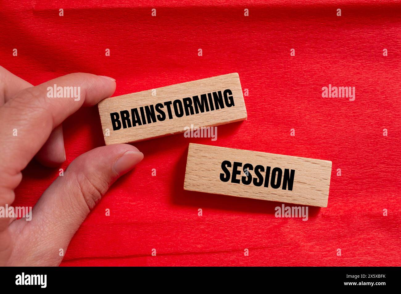 Brainstorming session words written on wooden blocks with red ...