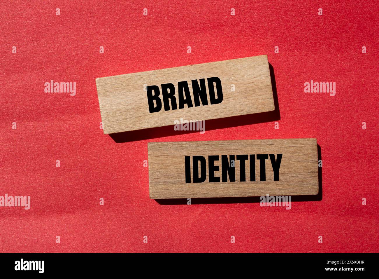 Brand identity words written on wooden blocks with red background ...