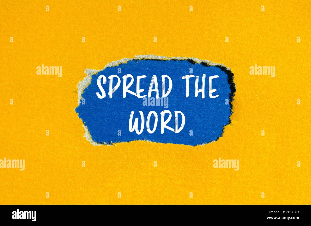 Spread the word words written on ripped yellow paper with blue ...