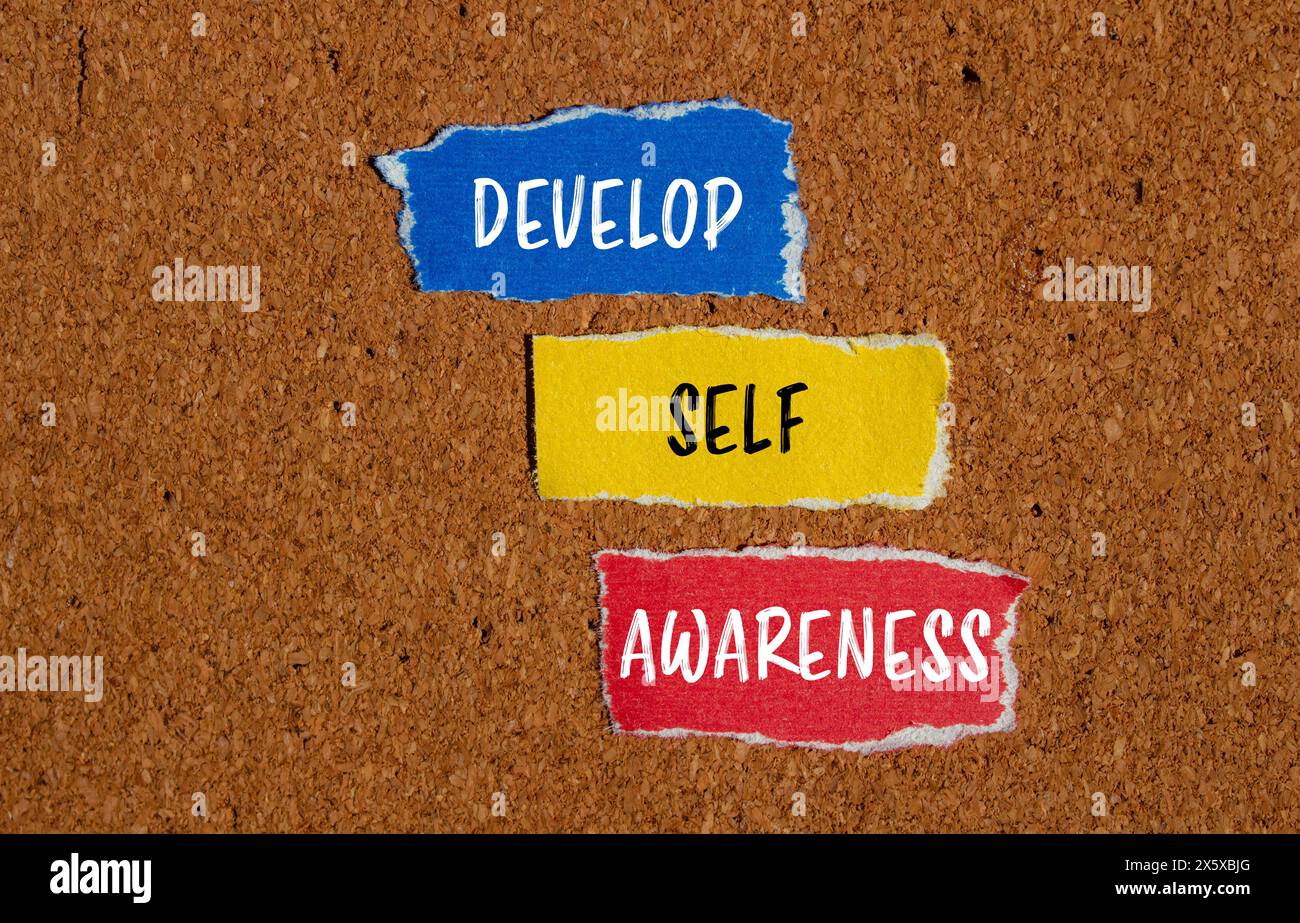 Develop self awareness words written on ripped paper pieces with brown ...