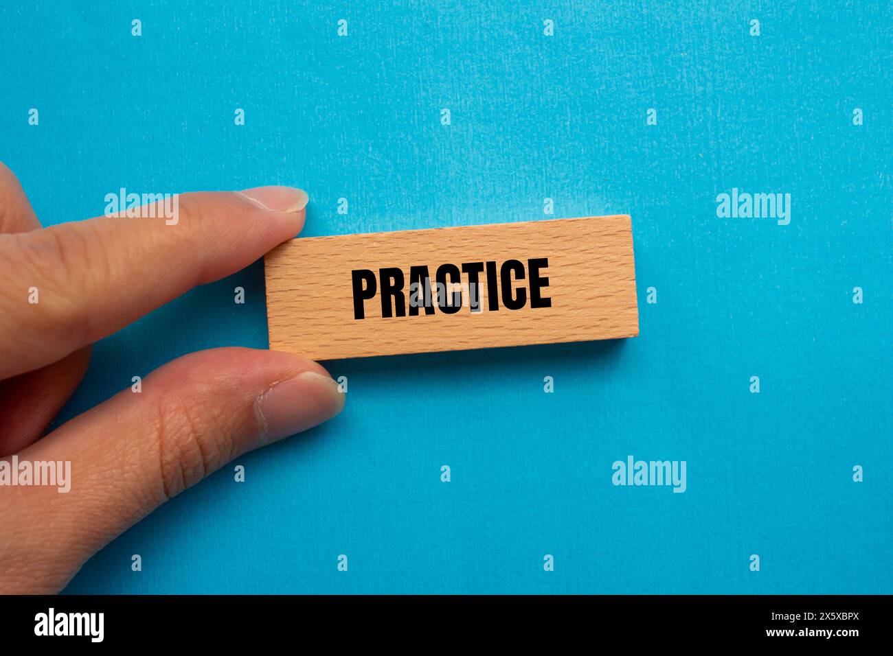 Practice word written on wooden block with blue background. Conceptual ...