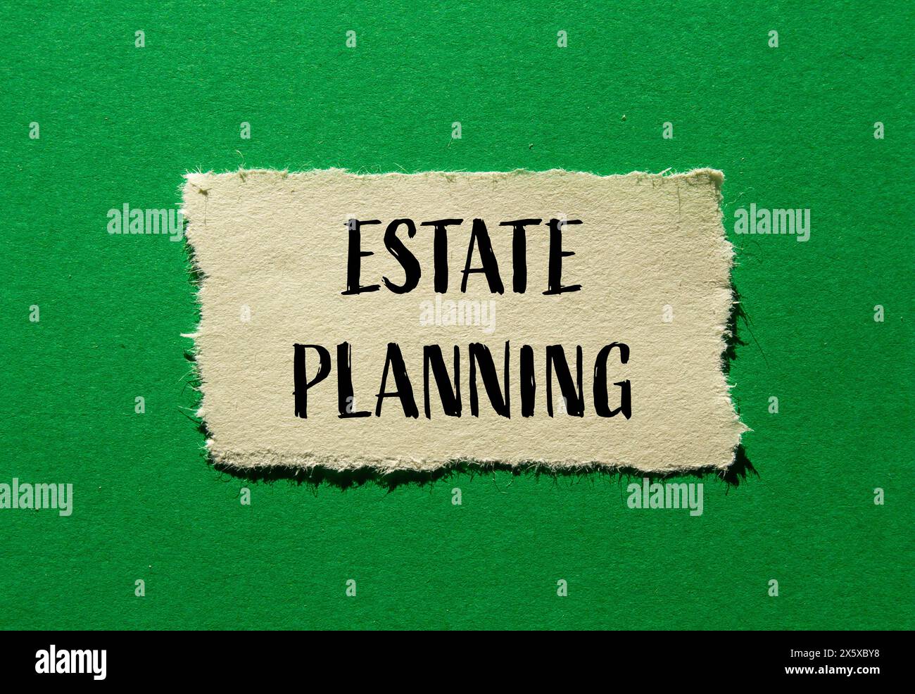 Estate planning words written on ripped paper with green background ...