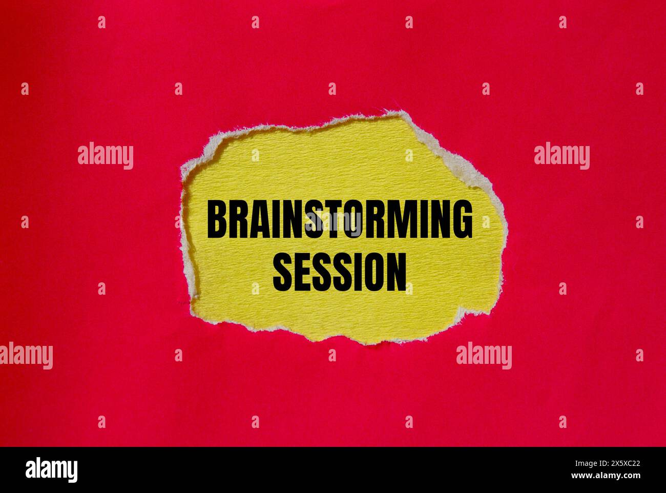 Brainstorming session words written on ripped red paper with yellow ...