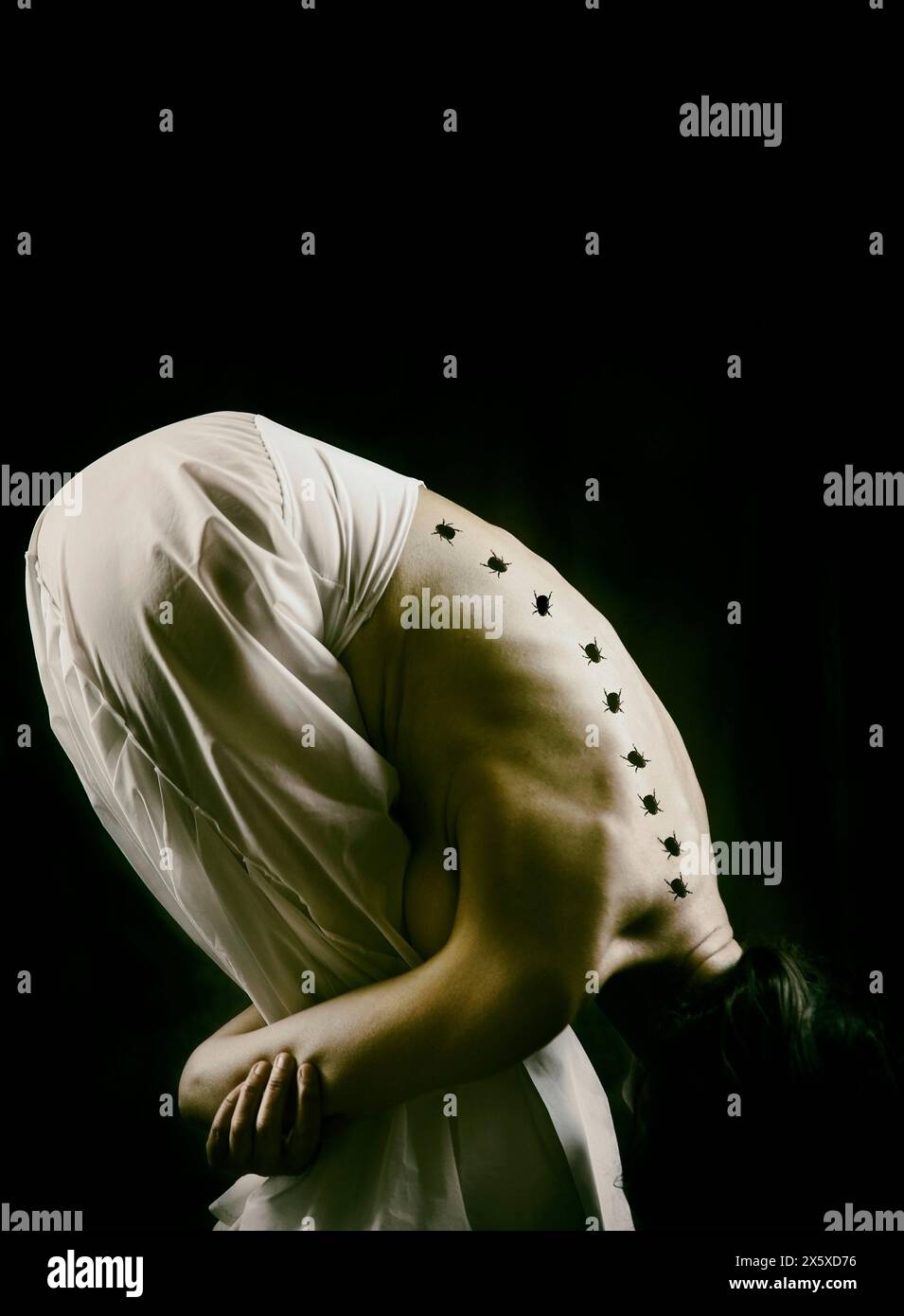 woman in white skirt bending over with beetles crawling on her back ...