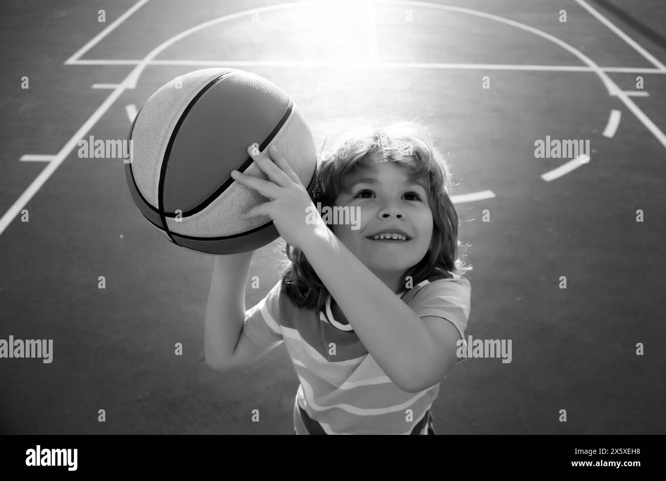 Cute child playing basketball. Portrait of sporty kid Stock Photo - Alamy