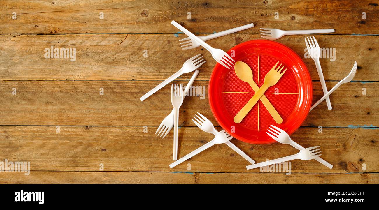 White single-use plastic forks and plates and wooden fork and spoon ...