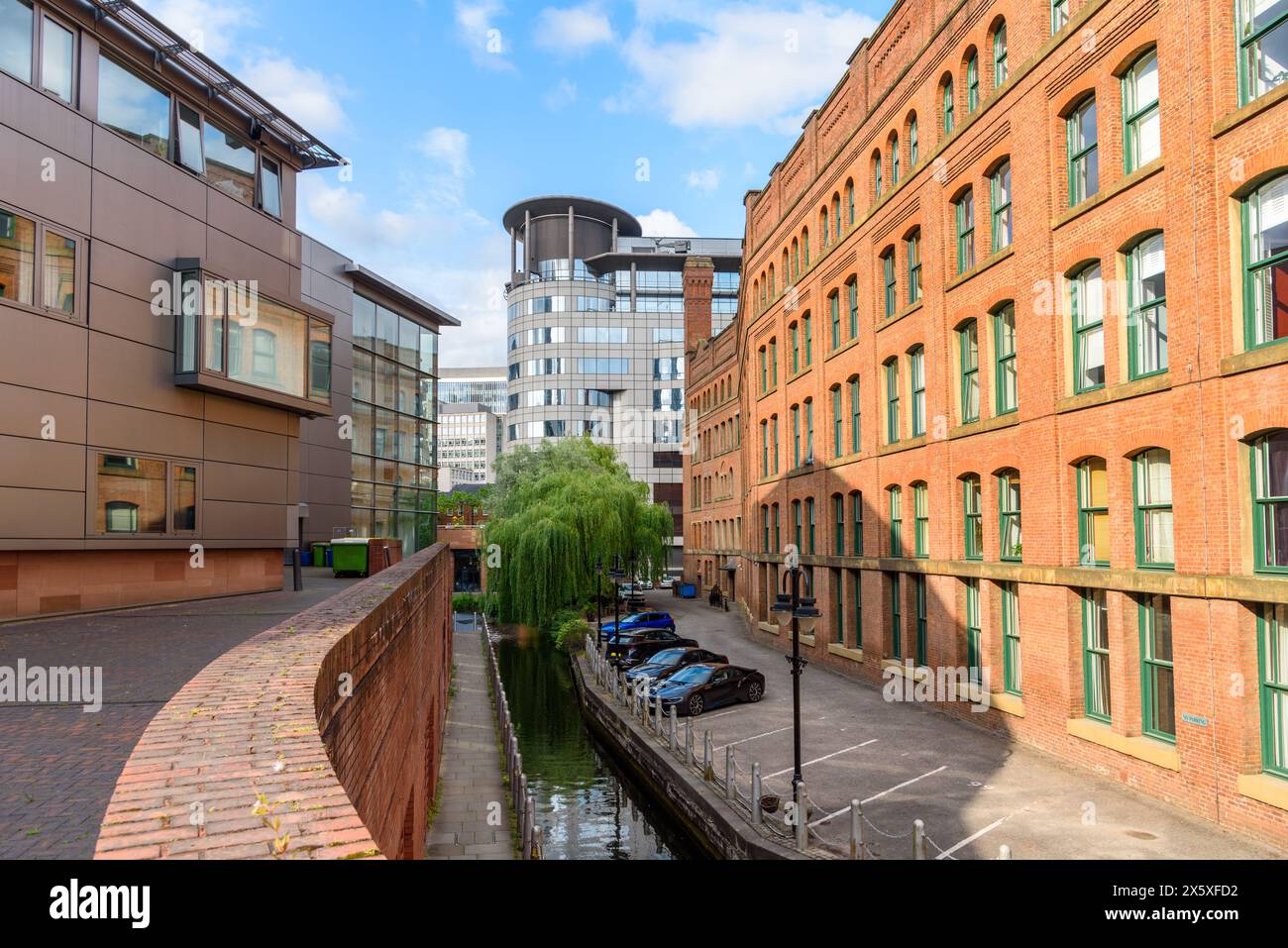 Narrow canal lined with a stone footpath between a renovated ...