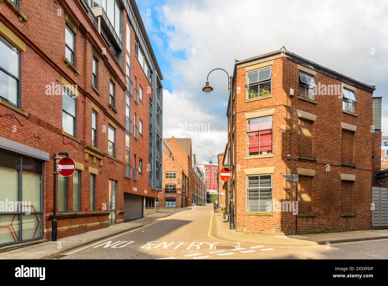 Cobbled street lined with old brick buildings converted into apartments ...