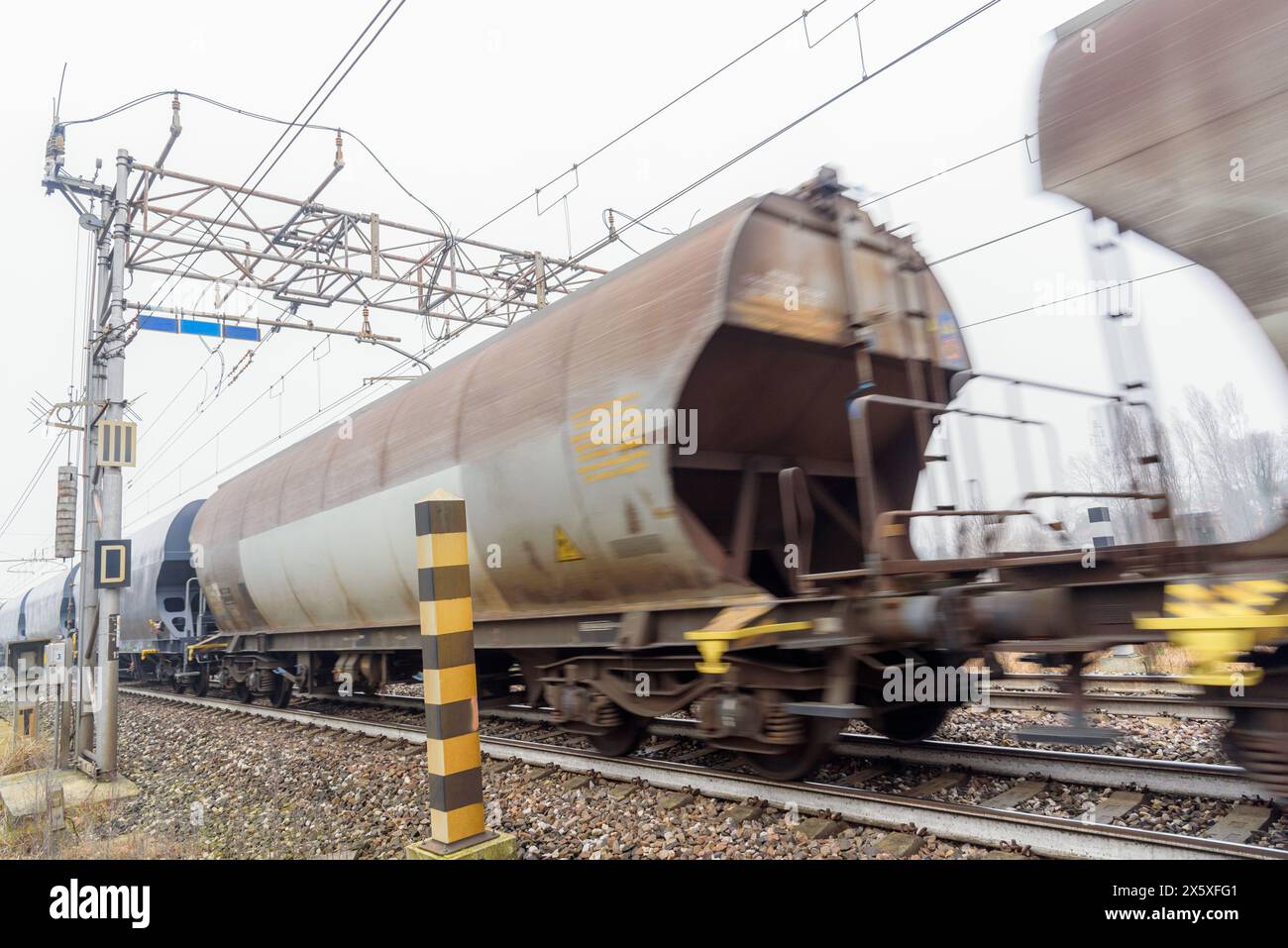 Passing freight train on a foggy winter day. Motion blur Stock Photo - Alamy