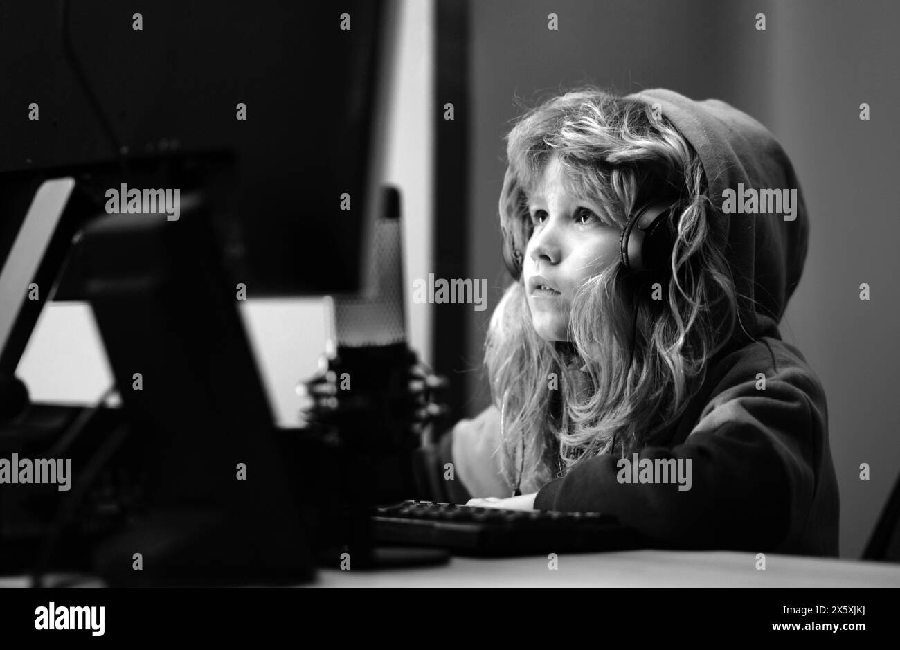 Little kid using desktop pc by night, child boy illuminated by the blue ...