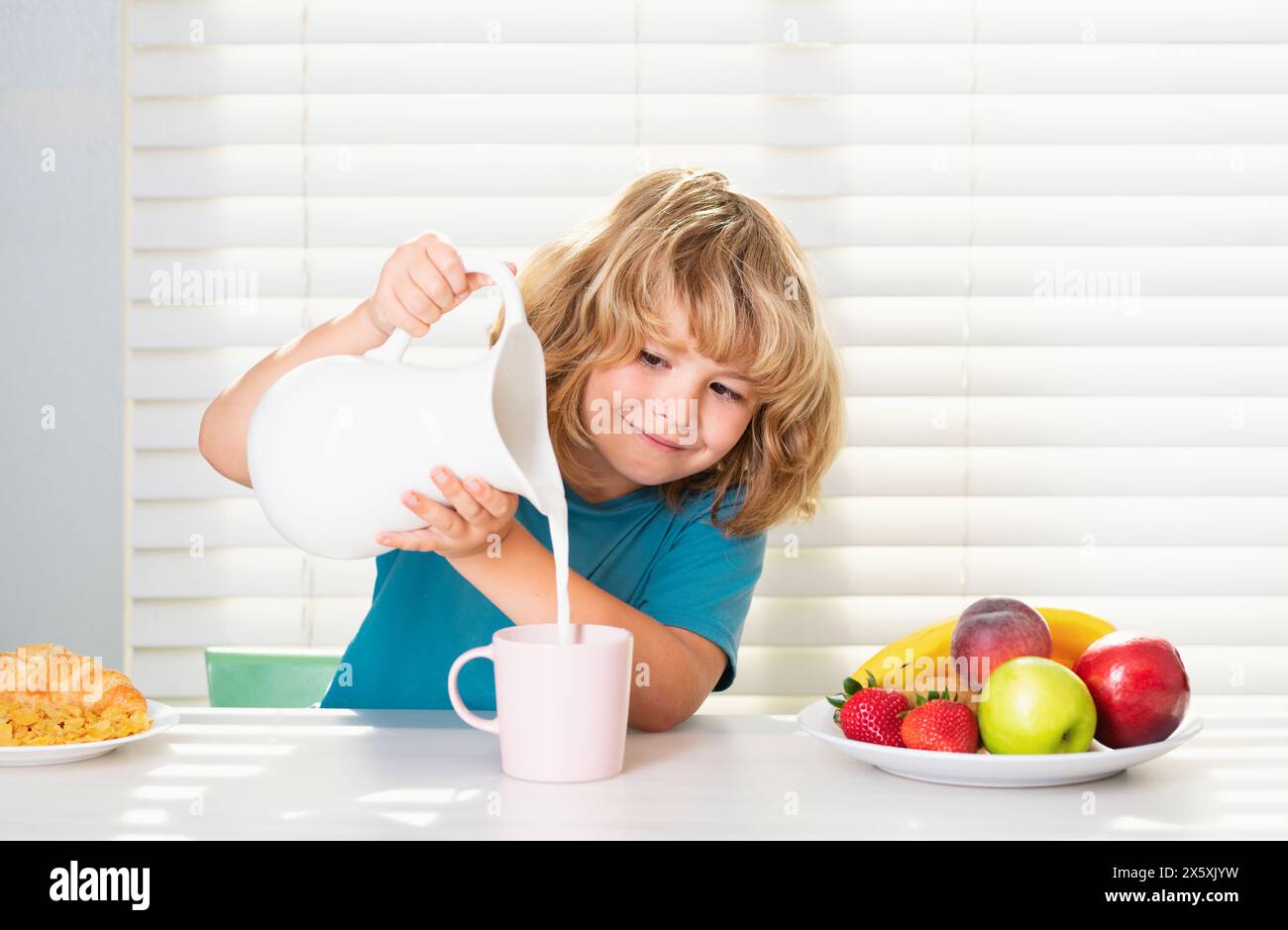 Kid boy pouring whole cows milk. Portrait of preteen child eat fresh ...