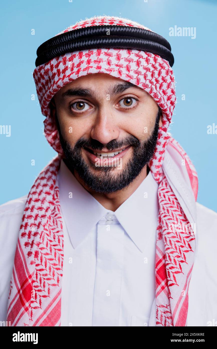 Excited muslim man wearing traditional islamic thobe and headscarf ...