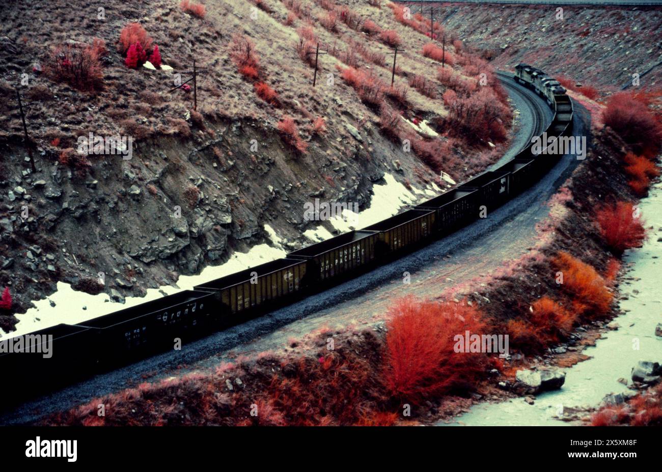 Freight train rounds a steep mountain bend alongside the Spanish Fork ...