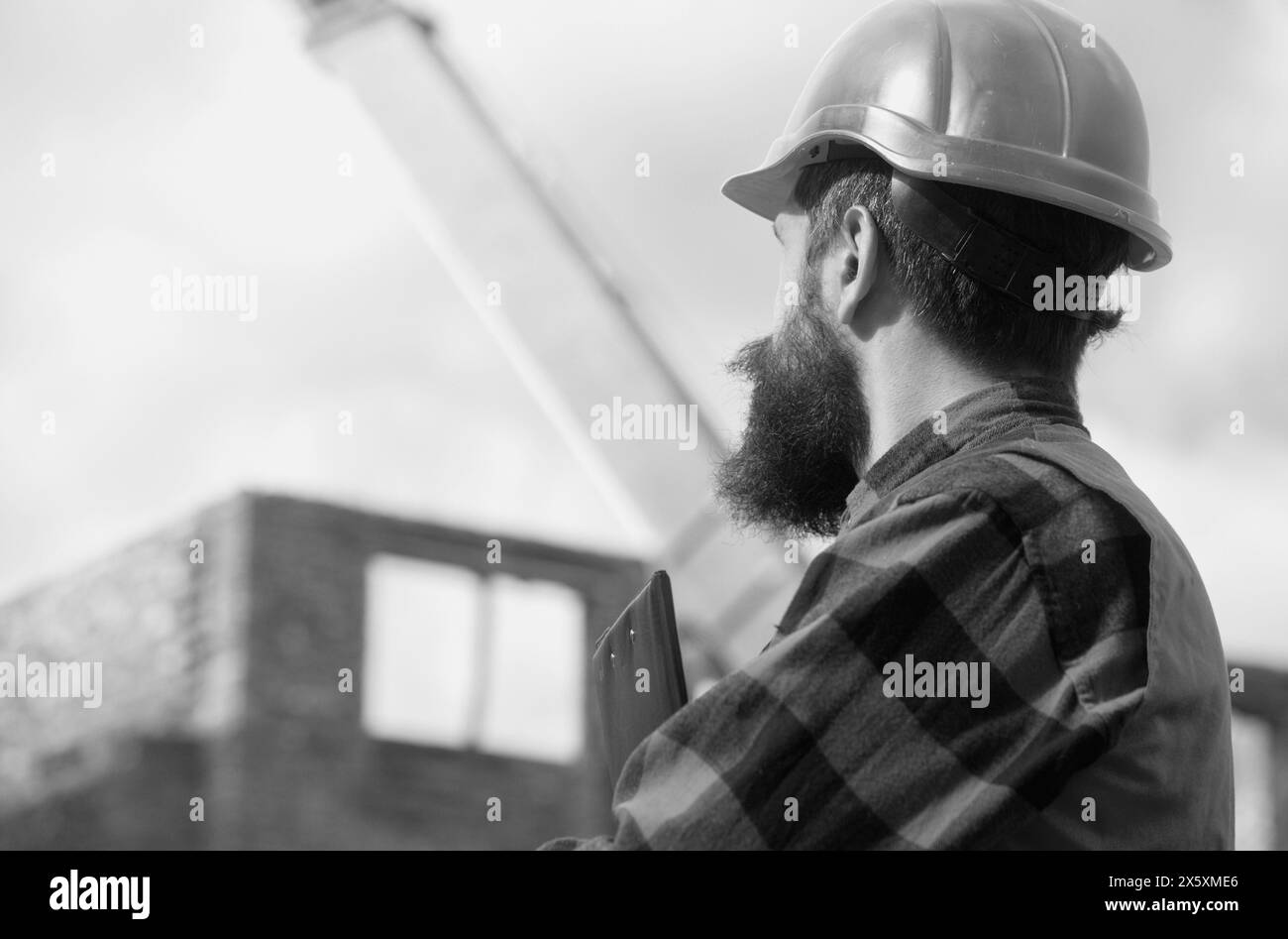 Builder worker in helmet posing on construction site. Portrait of ...