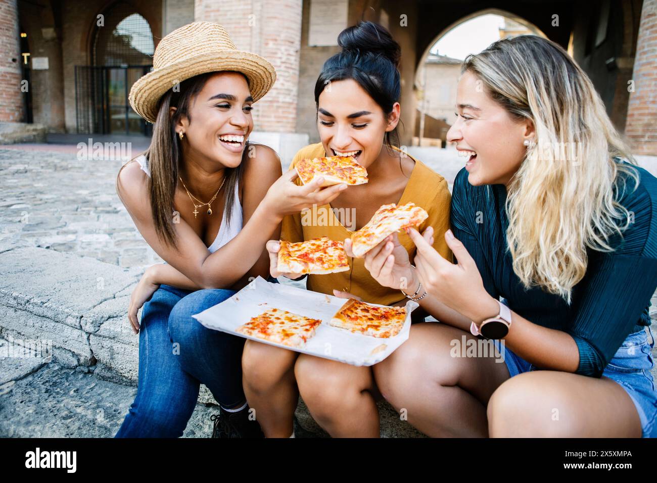 Multiracial tourist friends having fun eating italian pizza during ...