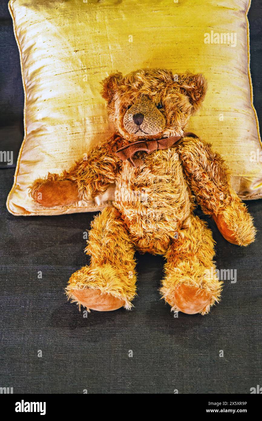 vintage old teddy bear laying down on a pillow in the bed Stock Photo ...