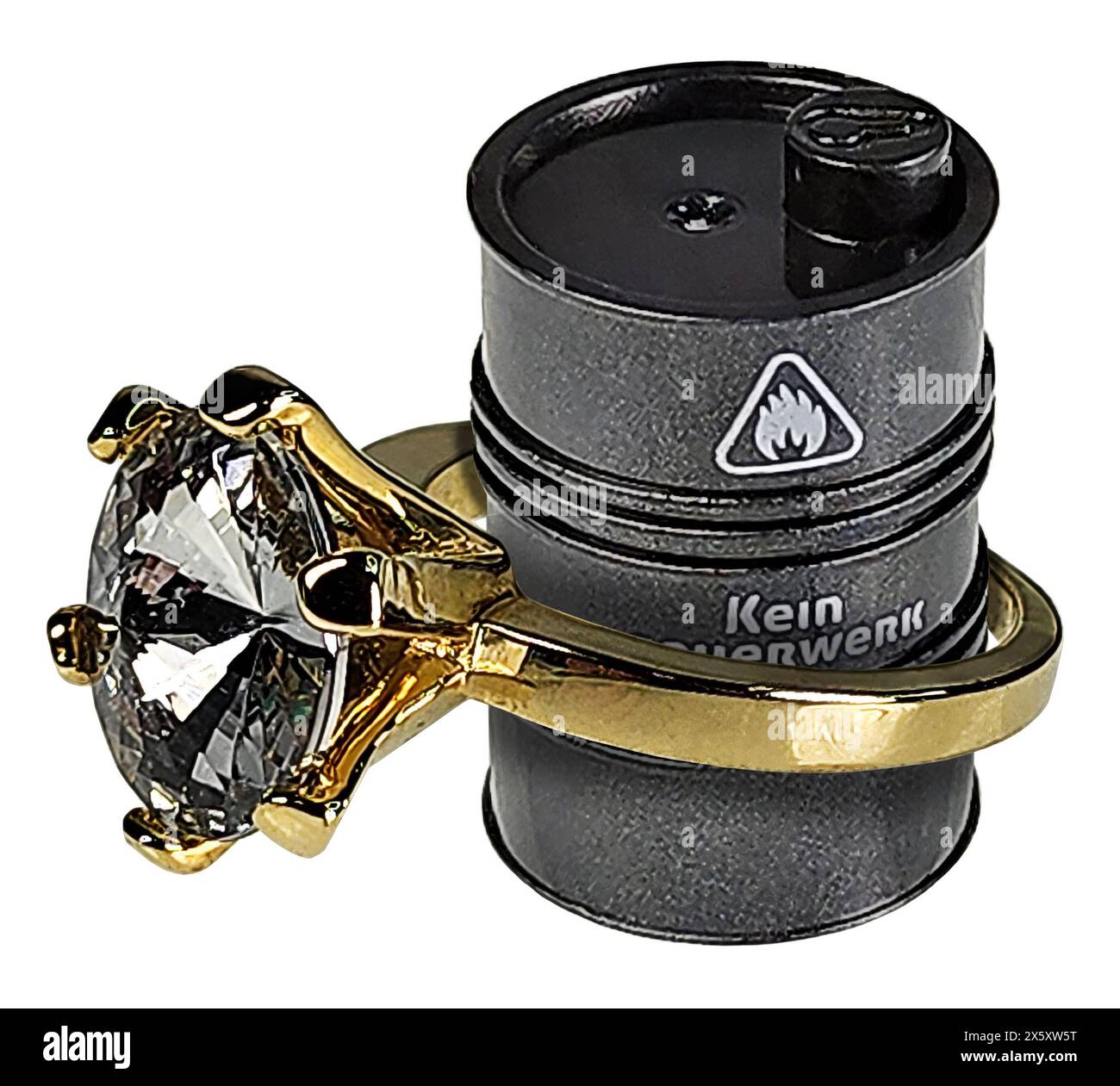 A large gold diamond ring around a steel drum for caustic substances to ...