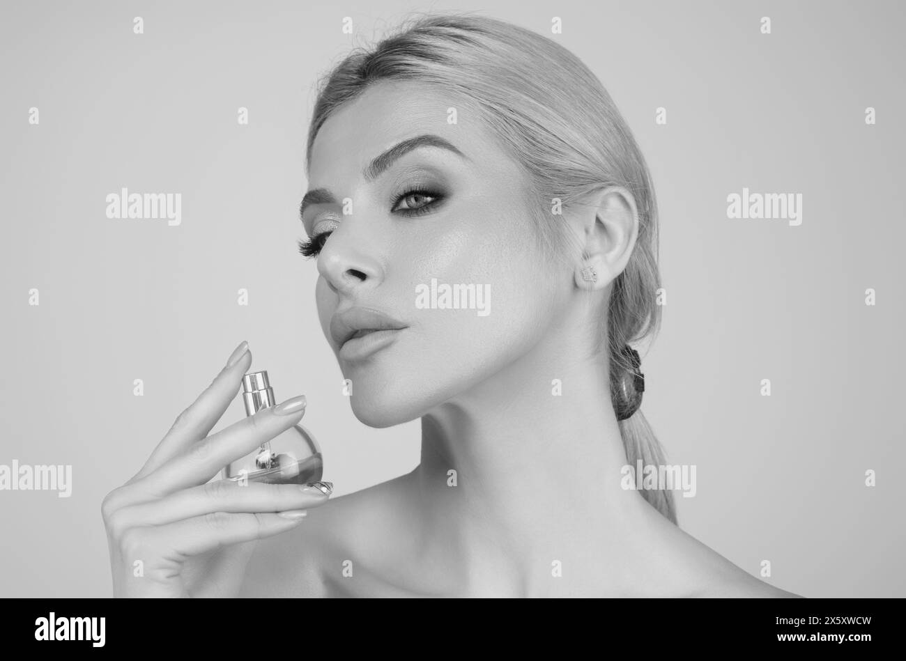 Beautiful romantic tender girl using perfume. Woman with bottle of ...