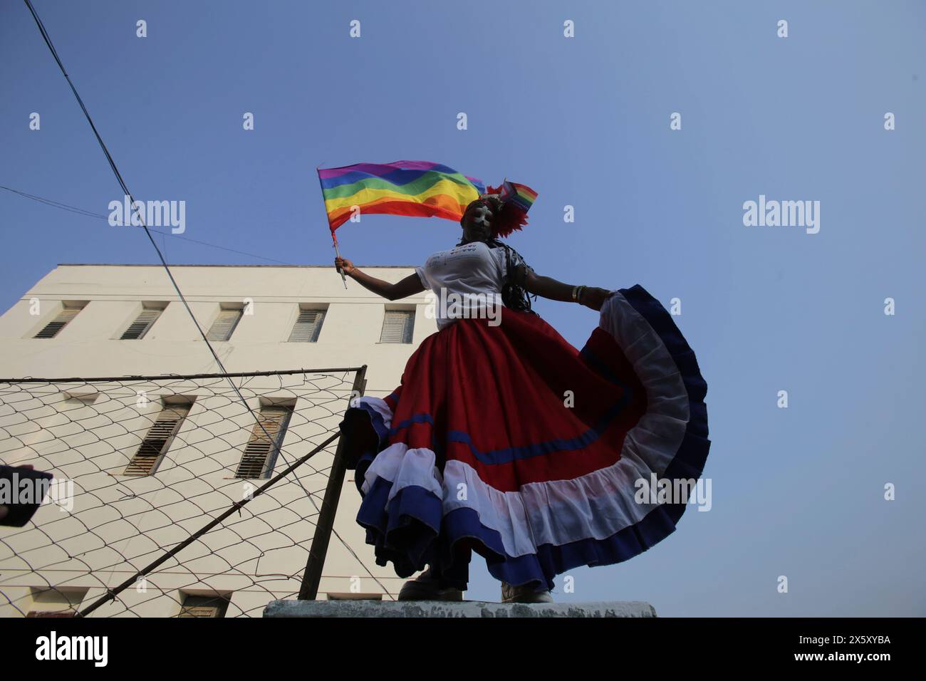 A member of Cuba's LGBTQ community dances during a gay pride march in ...