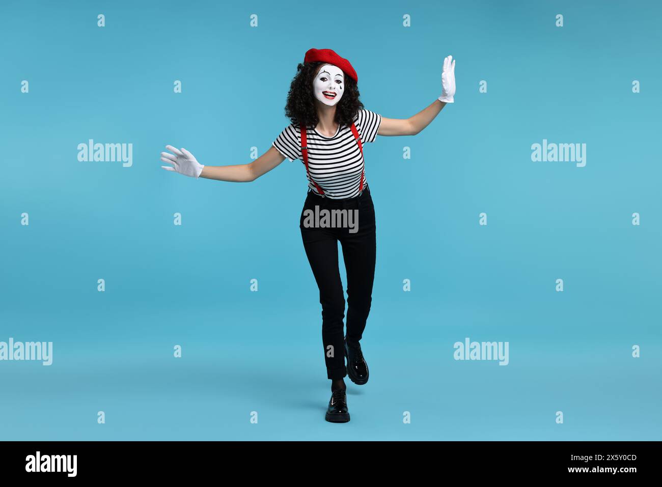 Funny mime with beret posing on light blue background Stock Photo - Alamy