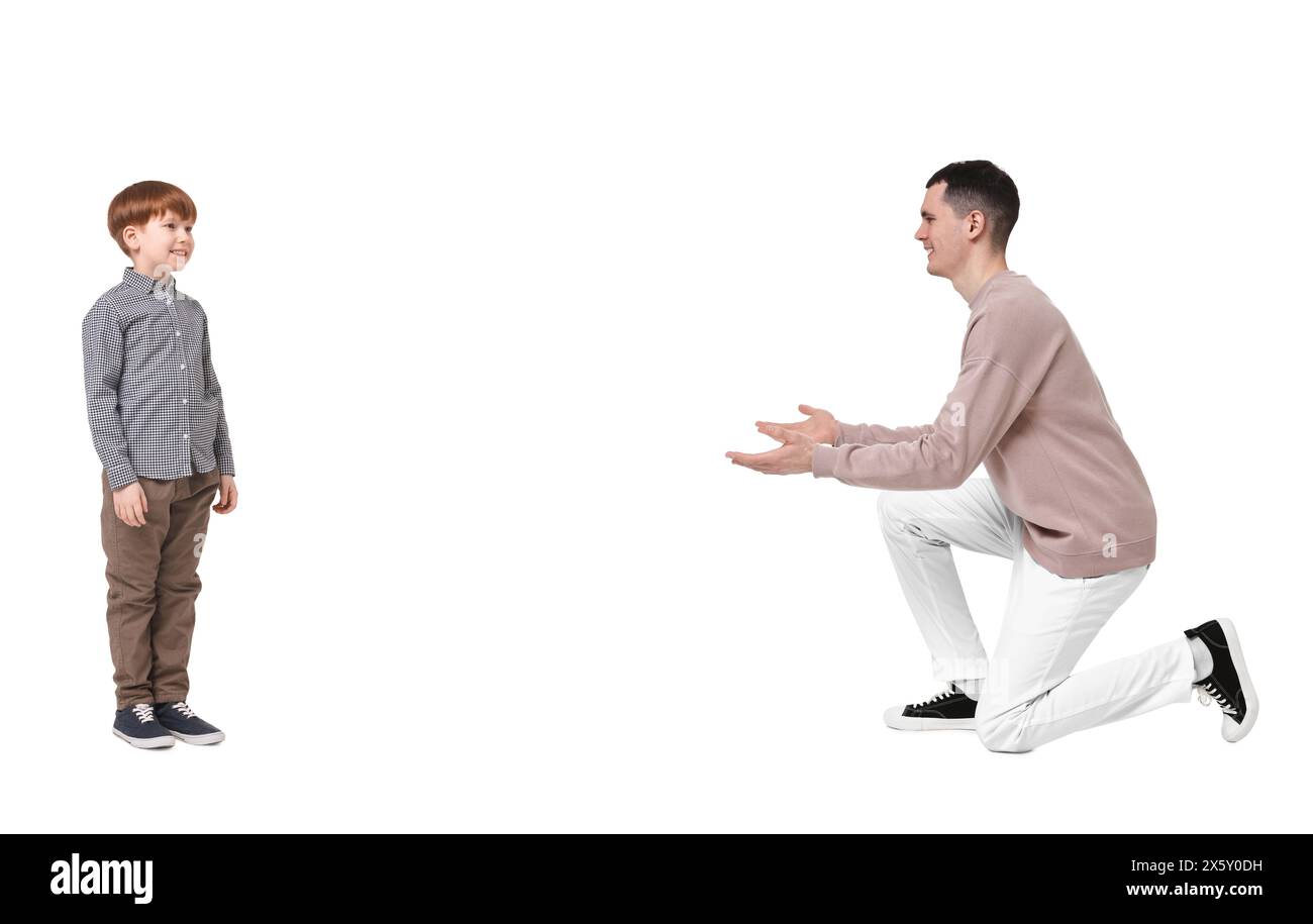 Father reaching for his son on white background Stock Photo - Alamy