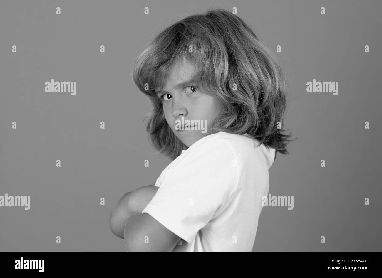 Portrait of angry child on studio isolated background. Upset kid upset ...