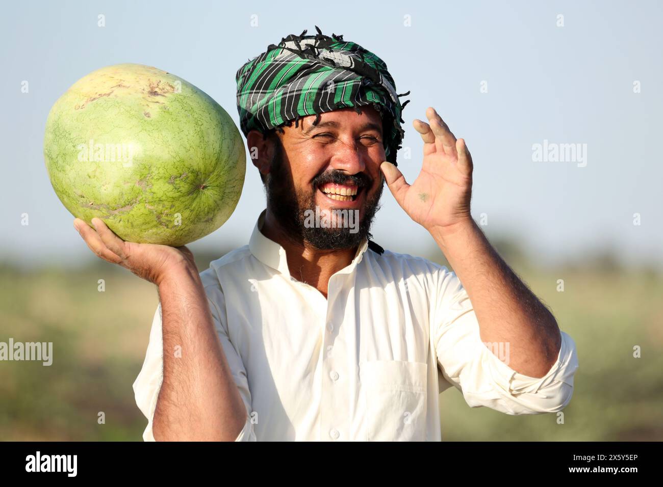 Baghdad, Iraq. 10th May, 2024. A farmer holds a newly-harvest ...