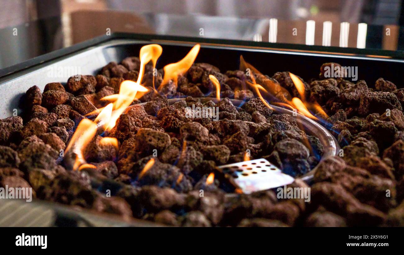 Stone firepit with fire flames. Summer camping bonfire Stock Photo - Alamy