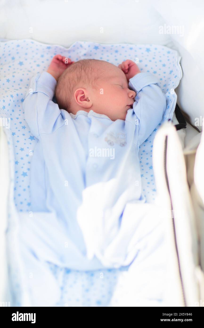 Newborn baby sleeping in white stroller on a walk in summer park. New ...