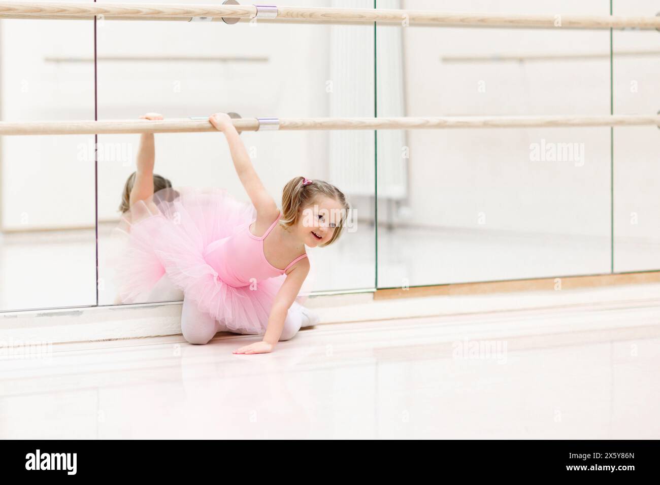 Little ballerina girl in a pink tutu. Adorable child dancing classical ...