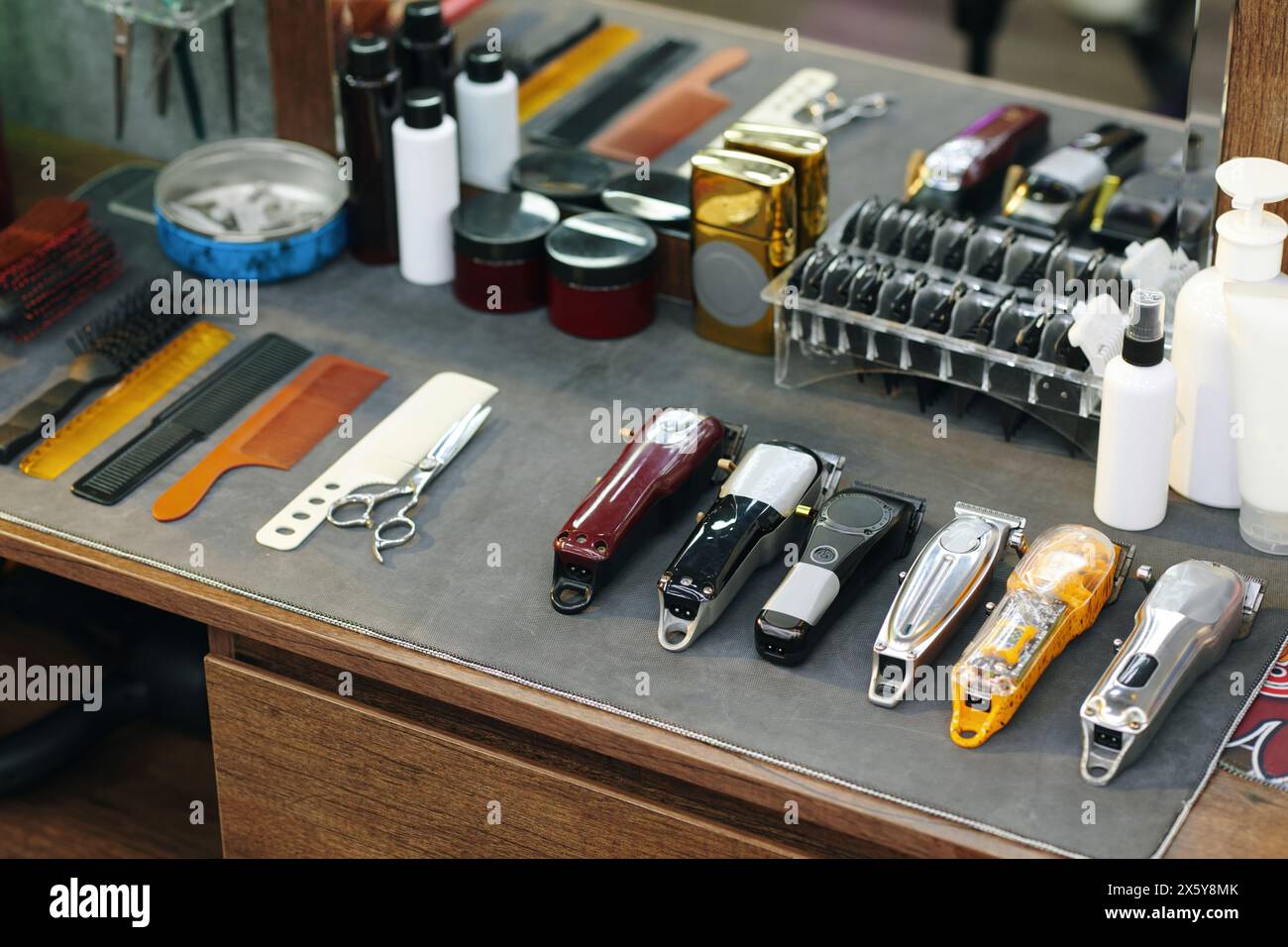 Set of clippers, combs and scissors on table on barber Stock Photo - Alamy