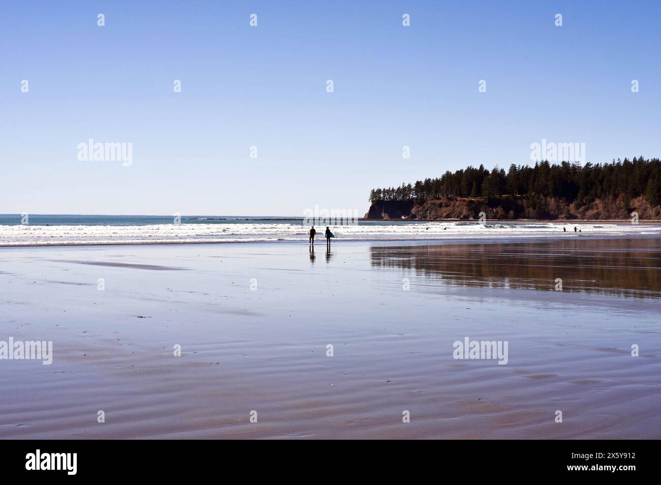 Two people with surfboards, walking on the beach at Hobuck Beach, Neah ...