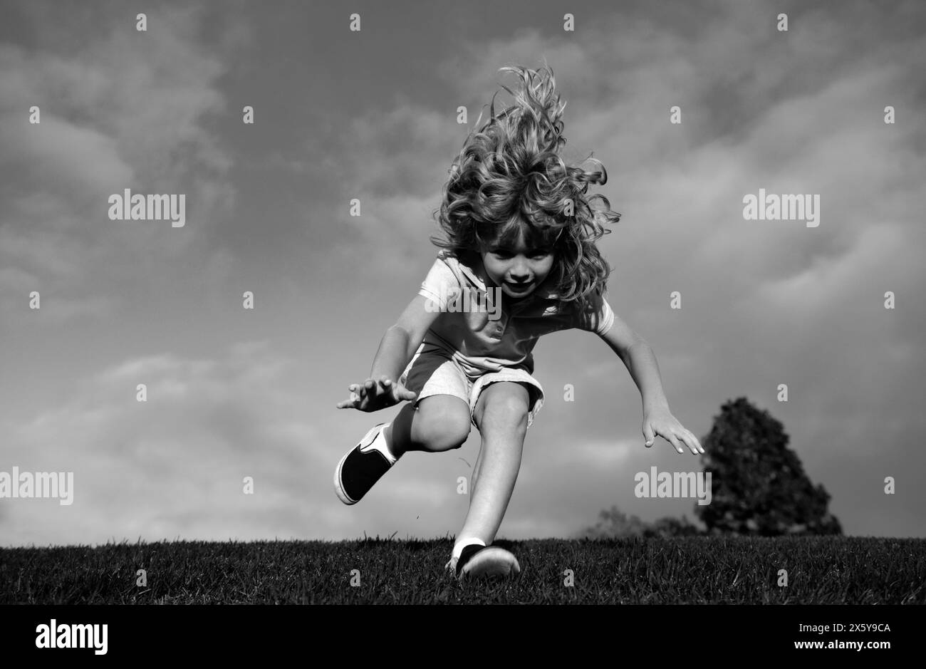 Boy falling down on grass. Kid falling off at the park. Child insurance ...