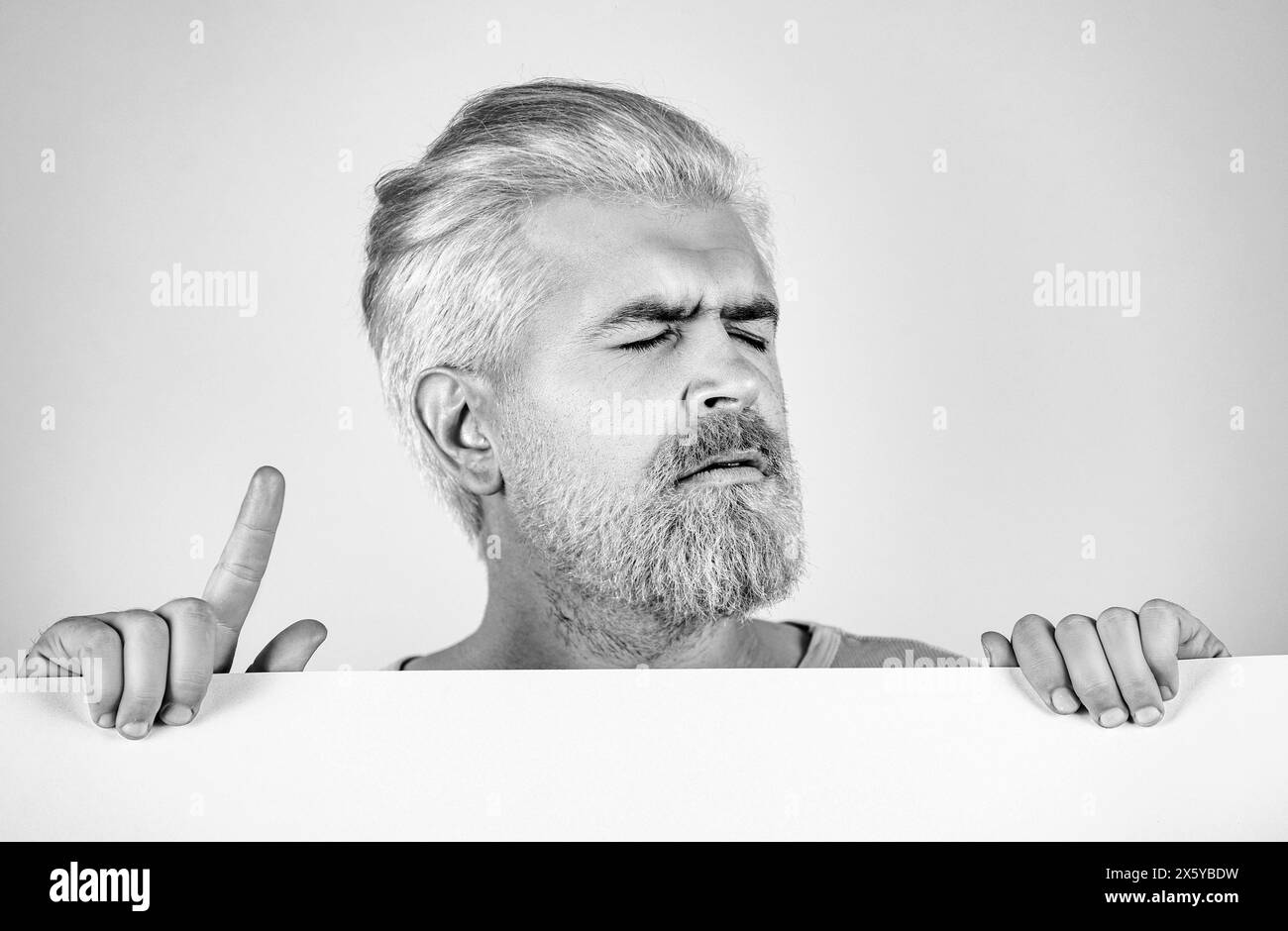 Man holding empty blank board. Caucasian blond male model posing in ...
