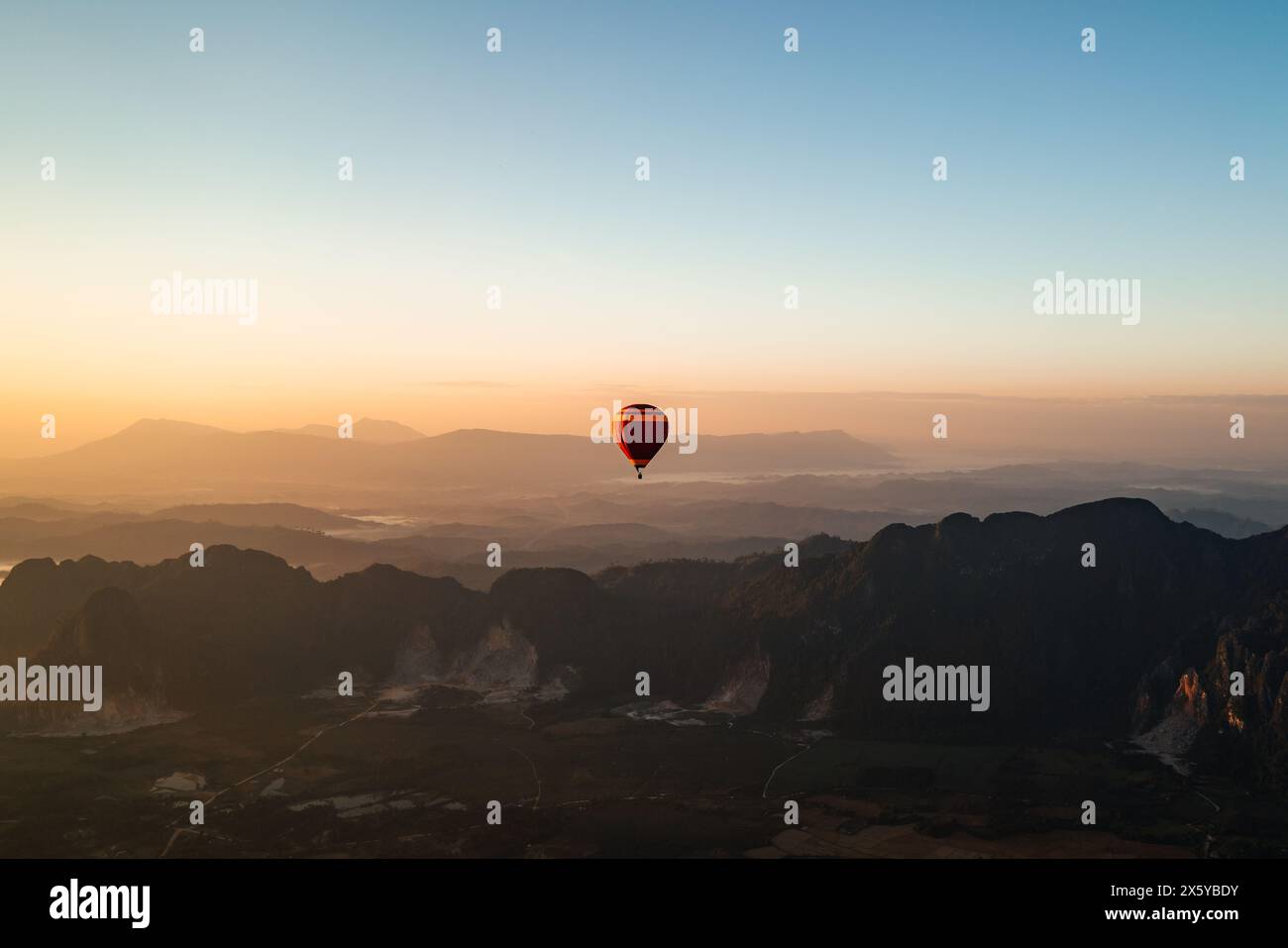 Red hot air balloon in Vang Vieng, Laos Stock Photo - Alamy