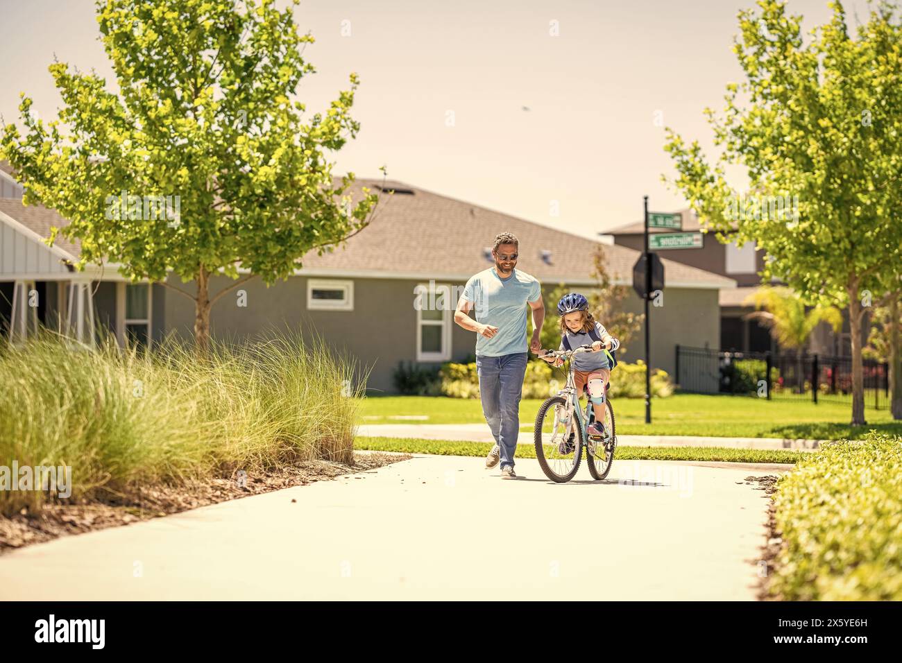 father and son on bicycle at fathers day. active father setting a ...