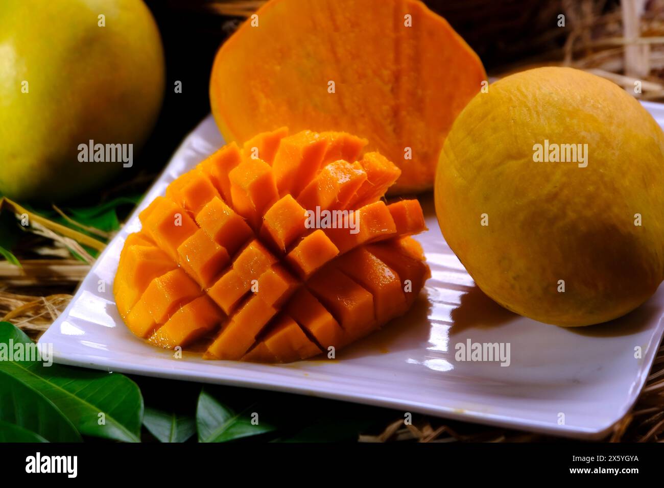 Mango tropical fruit with green leaf, Ripe mango in grass closeup, Cut ...