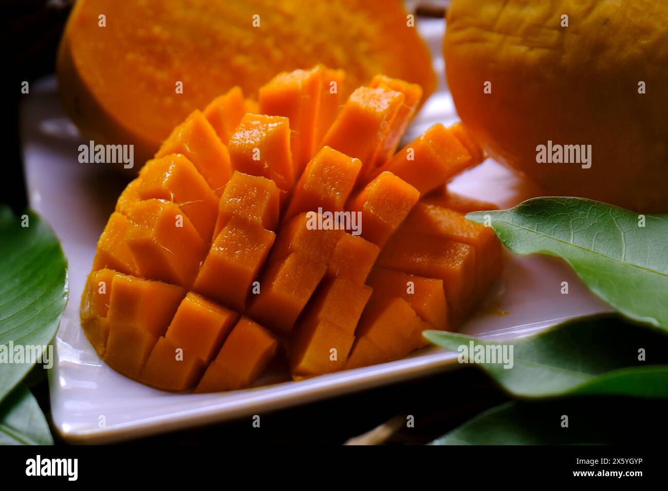 Mango tropical fruit with green leaf, Ripe mango in grass closeup, Cut ...