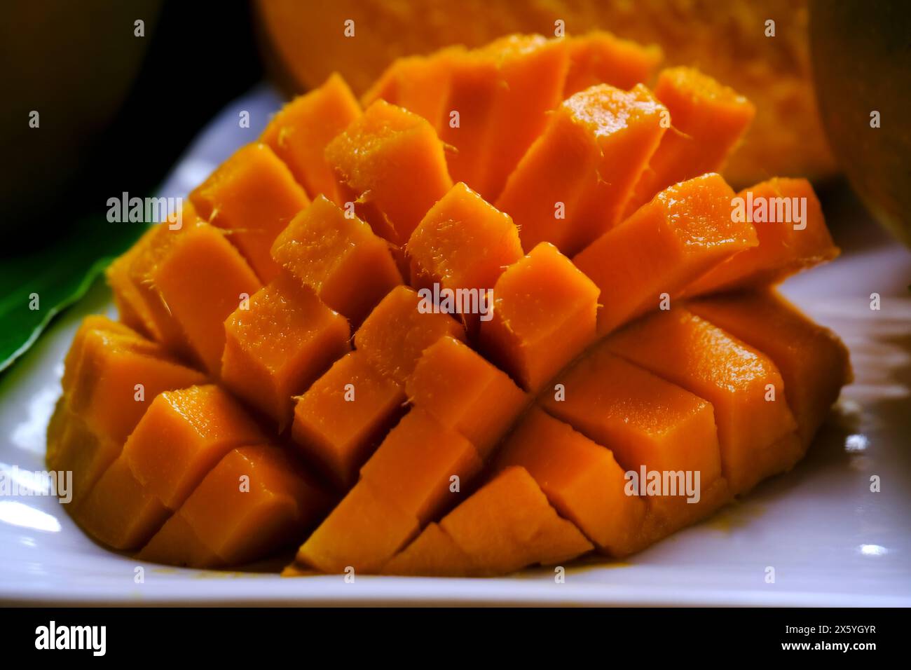 Mango tropical fruit with green leaf, Ripe mango in grass closeup, Cut ...