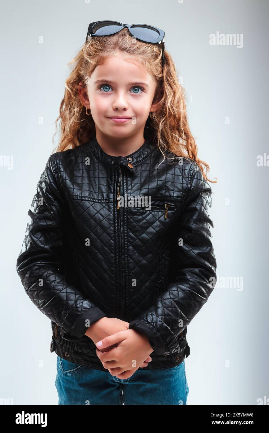 Young Girl With Blue Eyes And Curly Blonde Hair Wearing Sunglasses On Her Head And A Stylish