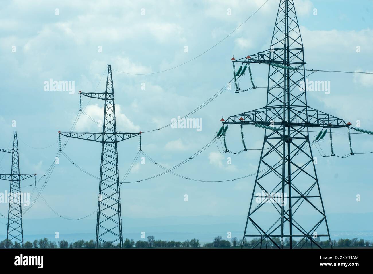 High voltage towers with sky background. Power line support with wires ...
