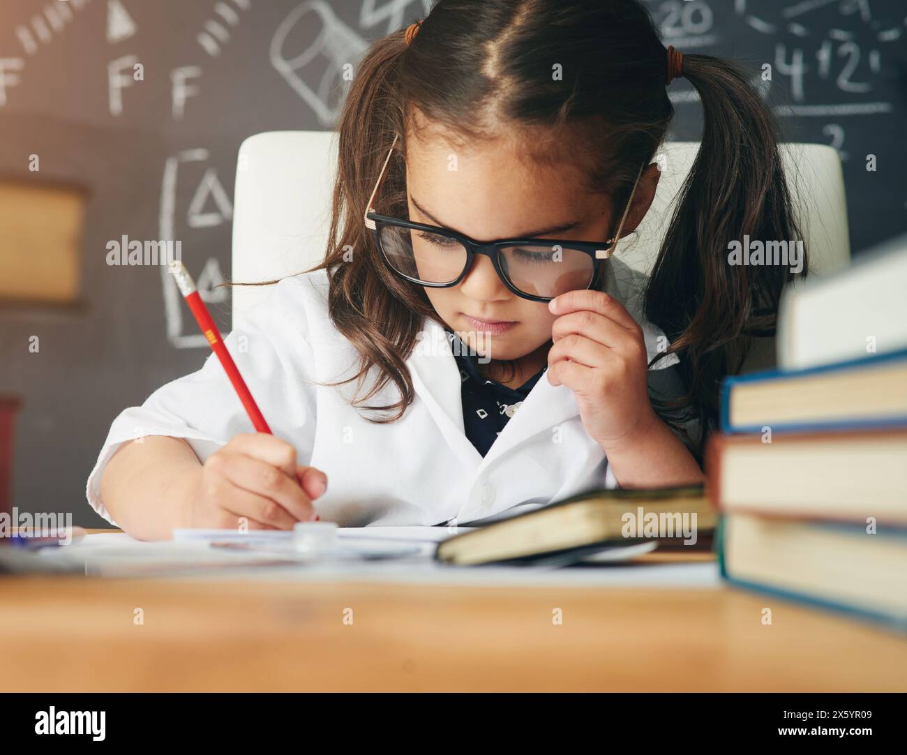 Student, writing and girl in classroom, education and knowledge with ...