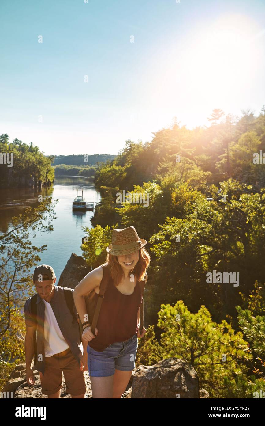 Nature, hiking and couple at river with blue sky on adventure holiday ...