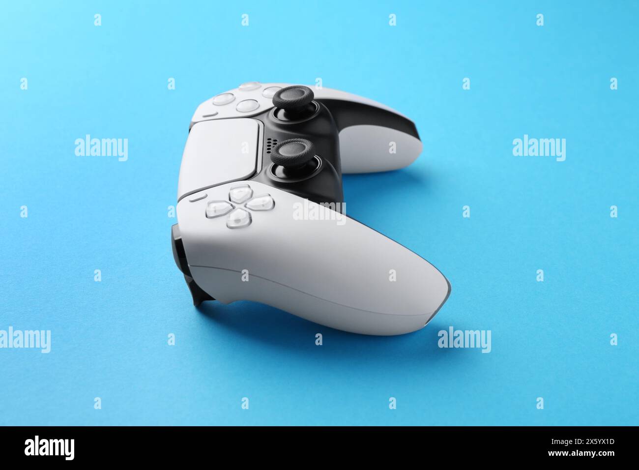 Wireless game controller on light blue background Stock Photo - Alamy
