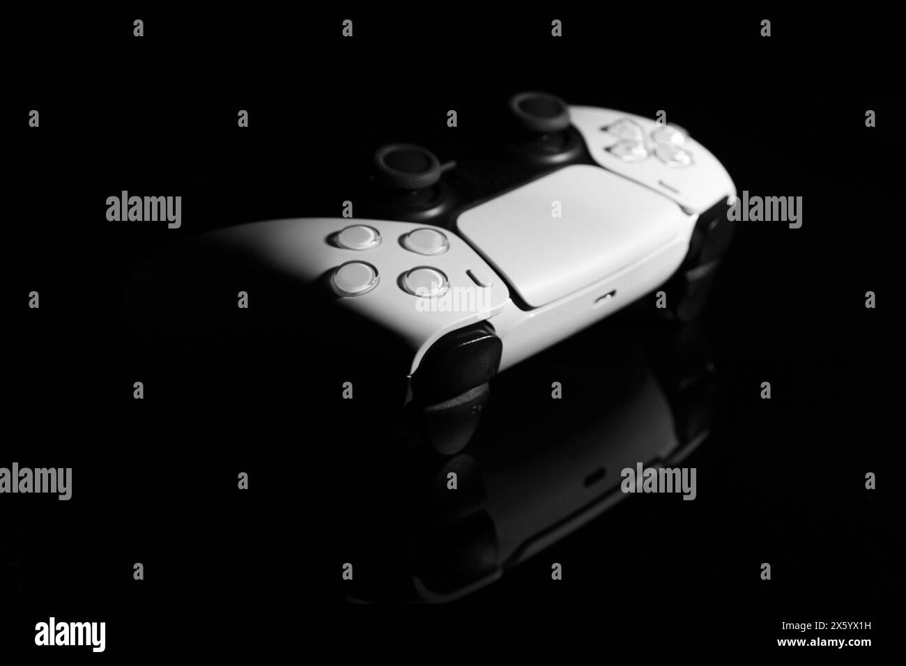 Wireless game controller on black mirror surface Stock Photo - Alamy