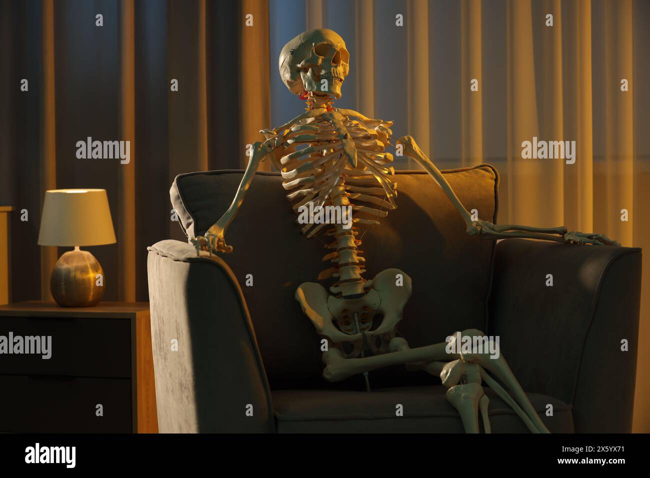 Waiting concept. Human skeleton sitting in armchair indoors Stock Photo ...
