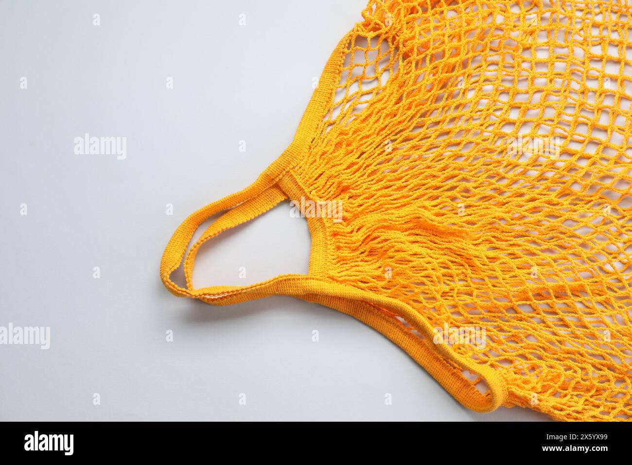 Orange string bag on light grey background, top view Stock Photo - Alamy