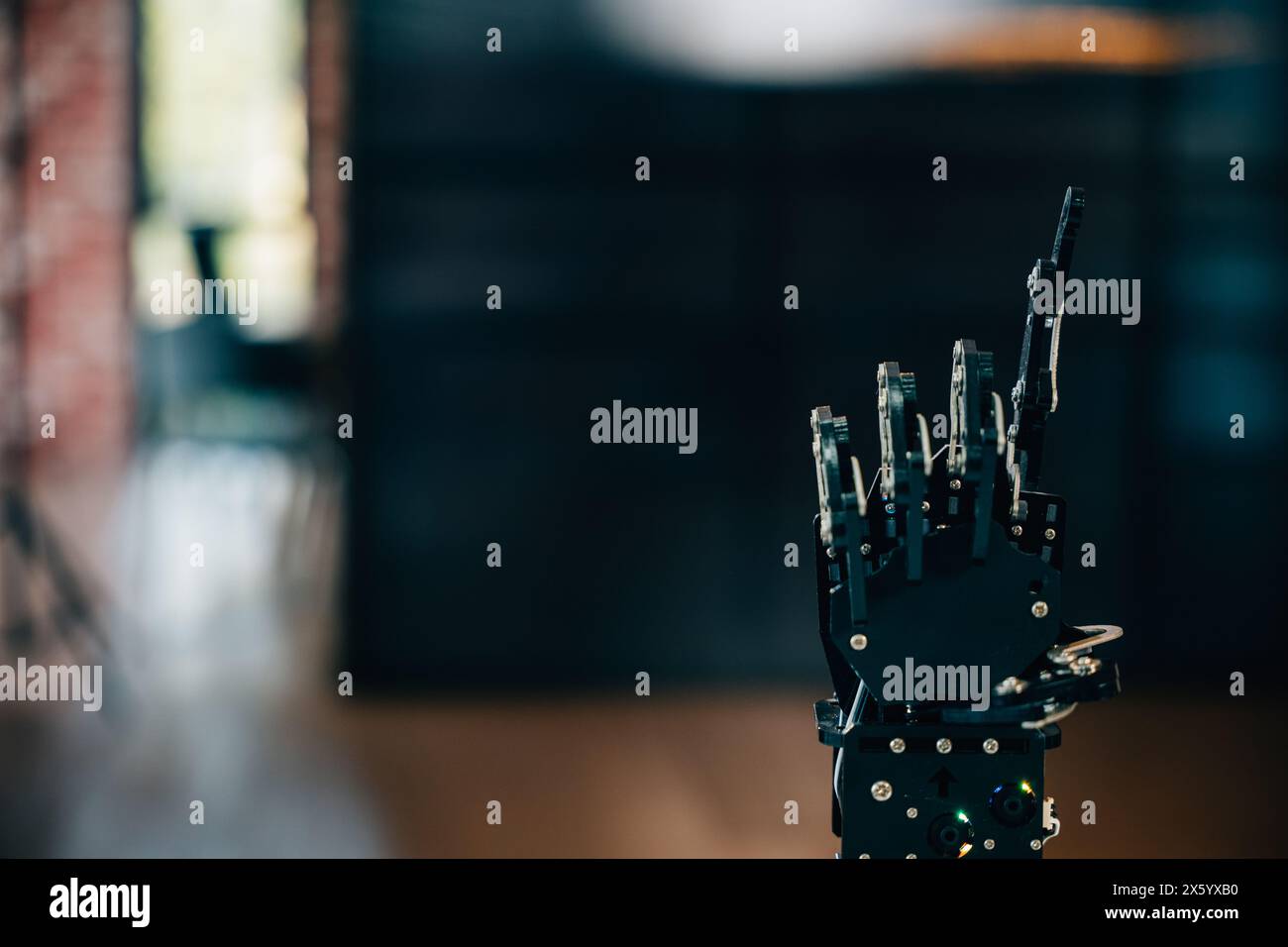 In a depiction of futuristic design a black real robot hand touches a ...