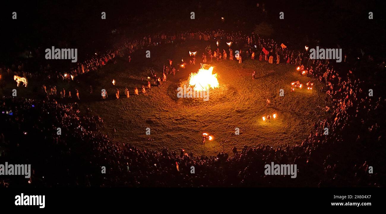 A crowd of just under 5000 people gathers around a huge bonfire during ...
